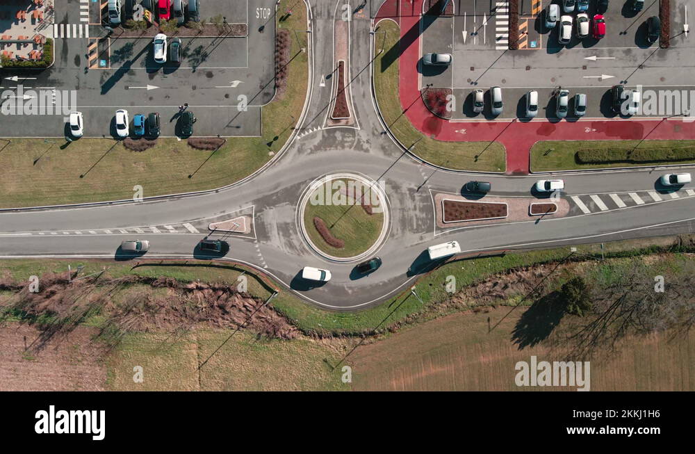 Top Down Aerial View of Daily Roundabout Traffic and Parking Lots in ...