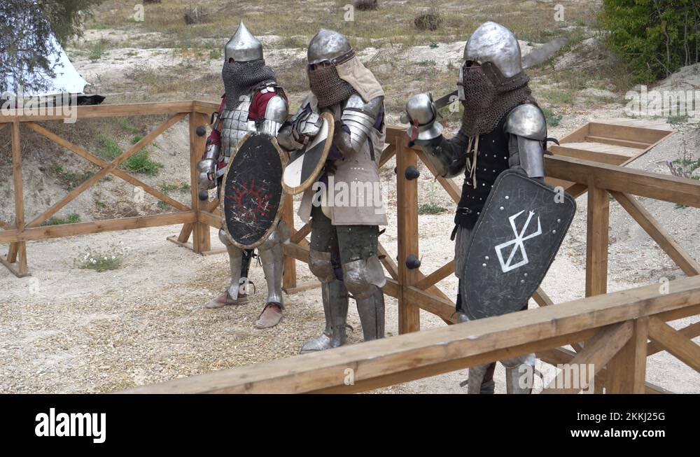 Medieval knight battle. Warriors in full plate armor with melee weapons ...