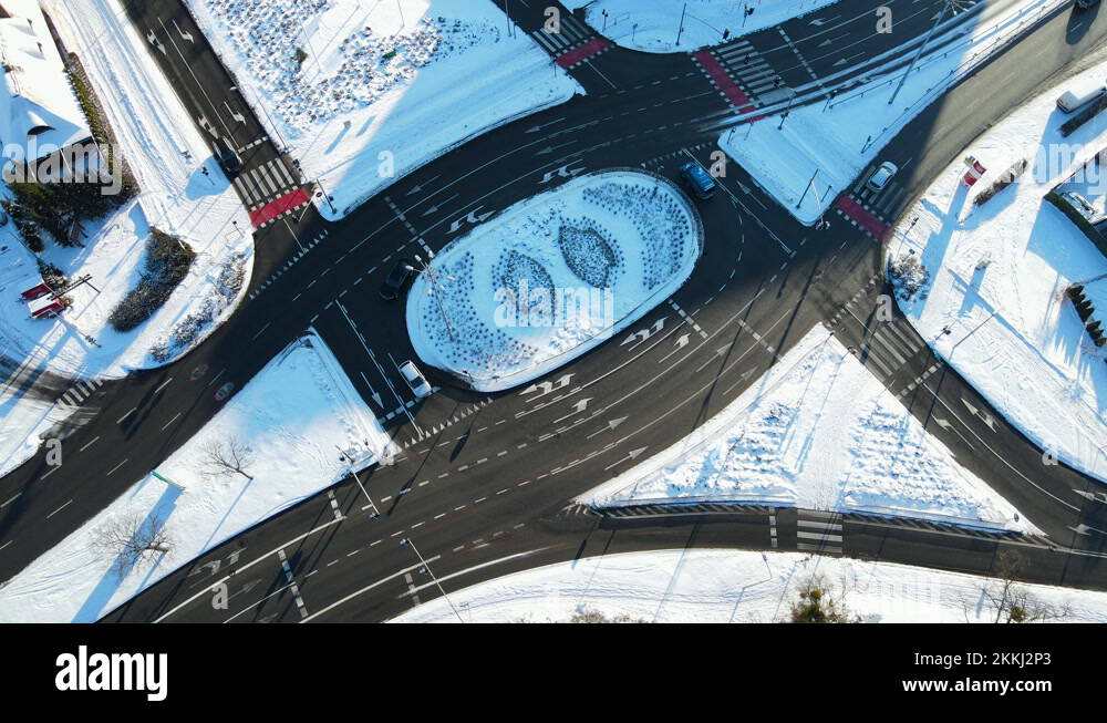 Cars driving over a giant roundabout equipped with traffic lights in a ...