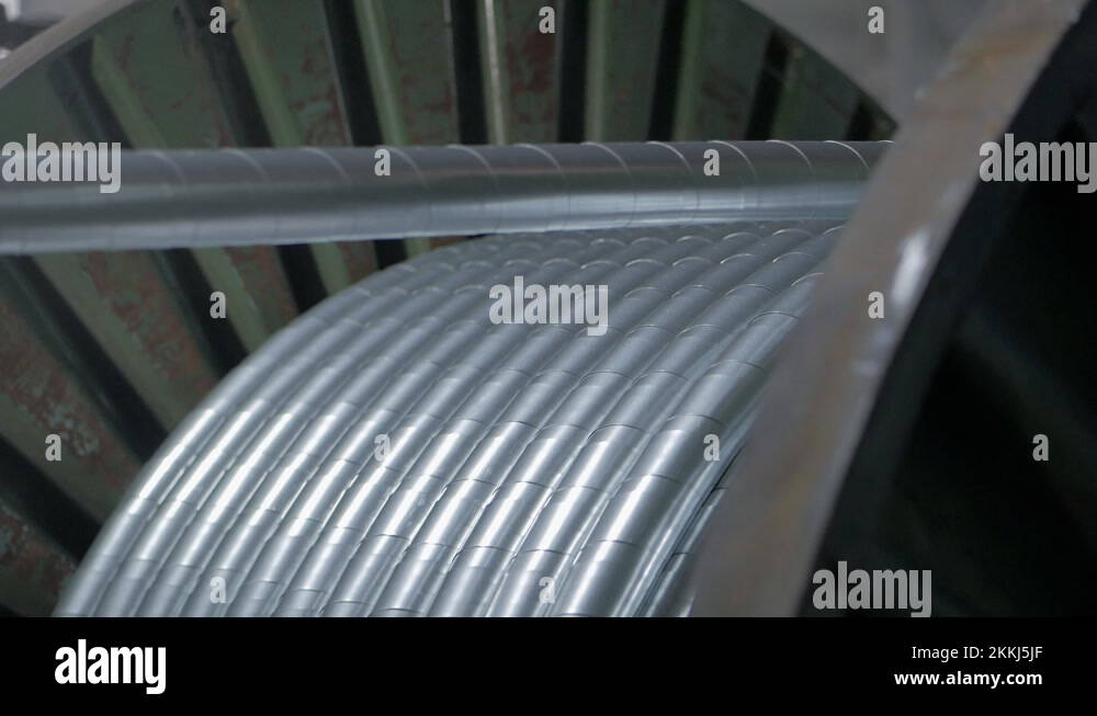 Close-up of the winding of a high-voltage electric cable on a coil in ...