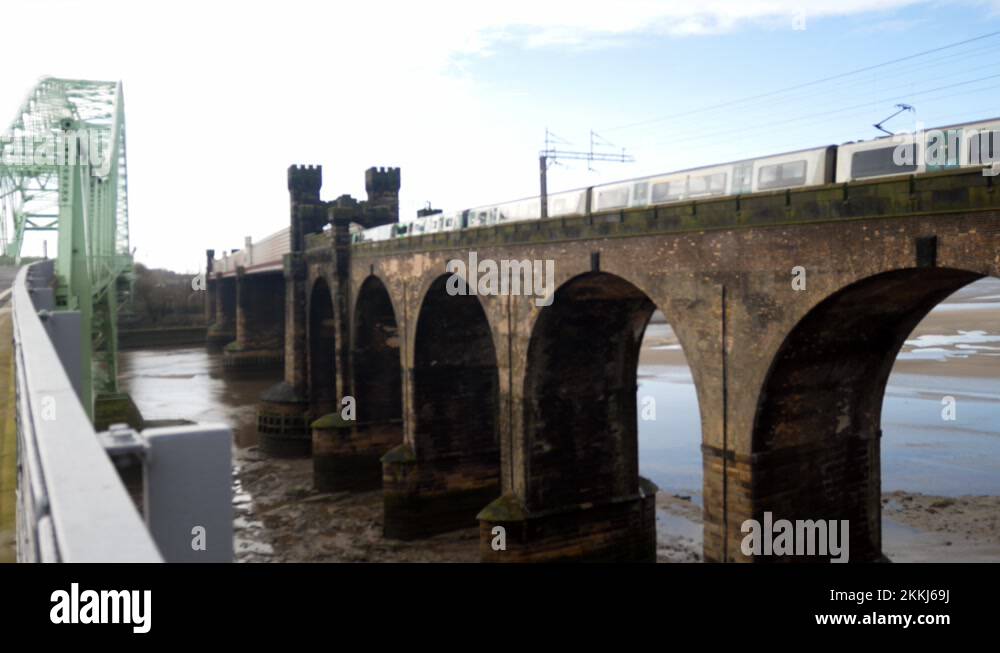 Public train crossing Runcorn bridge old castle turret building tower ...