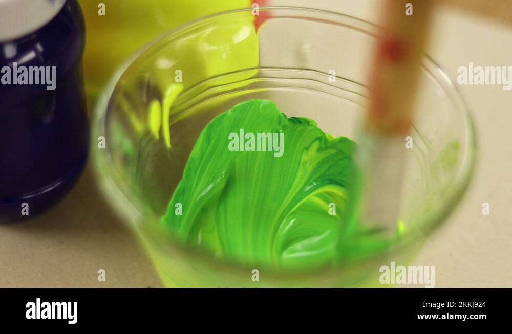 Mixing yellow and blue paint to create the green color. Crafts and diy ...