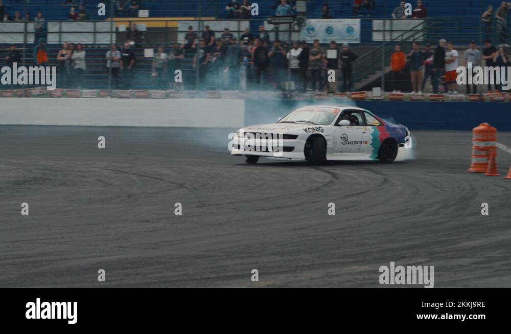 Modified Car Drifting Around a Racetrack Before Hitting Safety Cones ...
