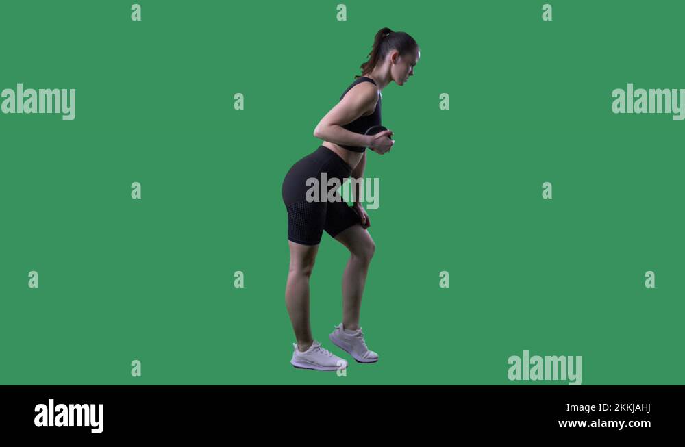 Side view of one arm triceps exercise by fit woman. Full body on green ...