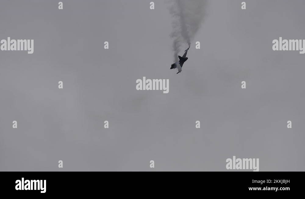 Slow motion video of fighter jet airplane black silhouette in grey sky ...