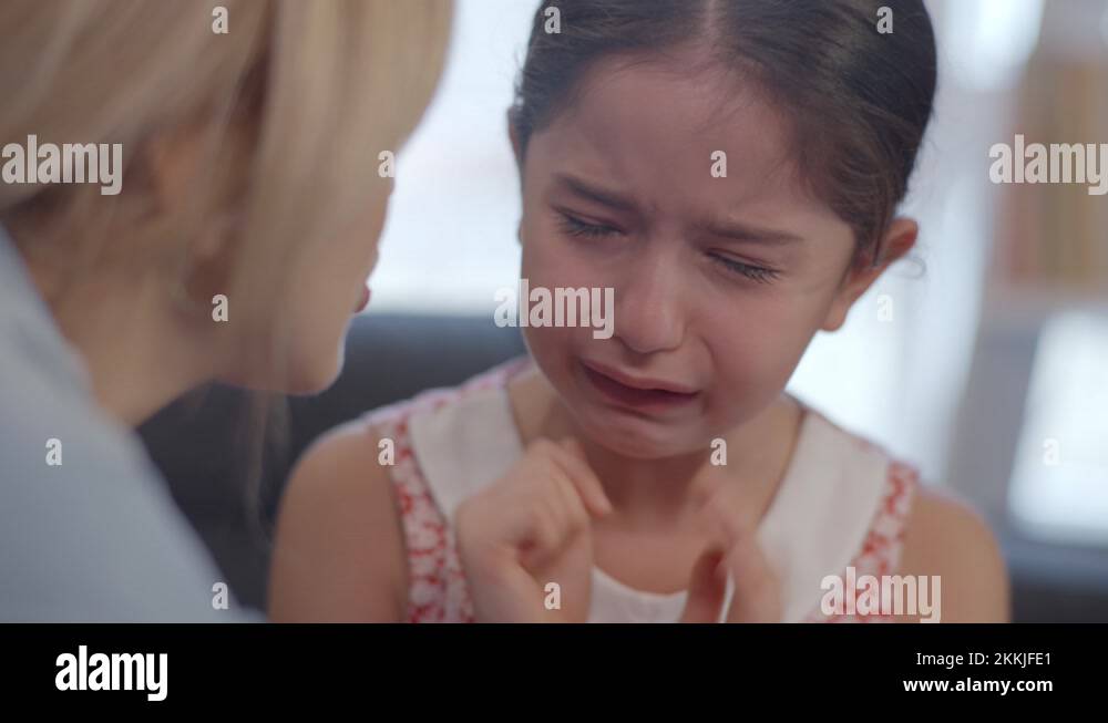Pretty little girl cries while sitting on the sofa Stock Video Footage ...