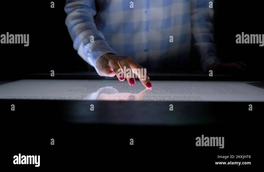 Woman using multimedia touchscreen display of interactive kiosk at ...