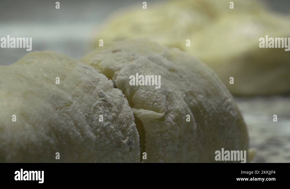 Bread dough is slowly cut with a thread. Back angle Stock Video Footage ...