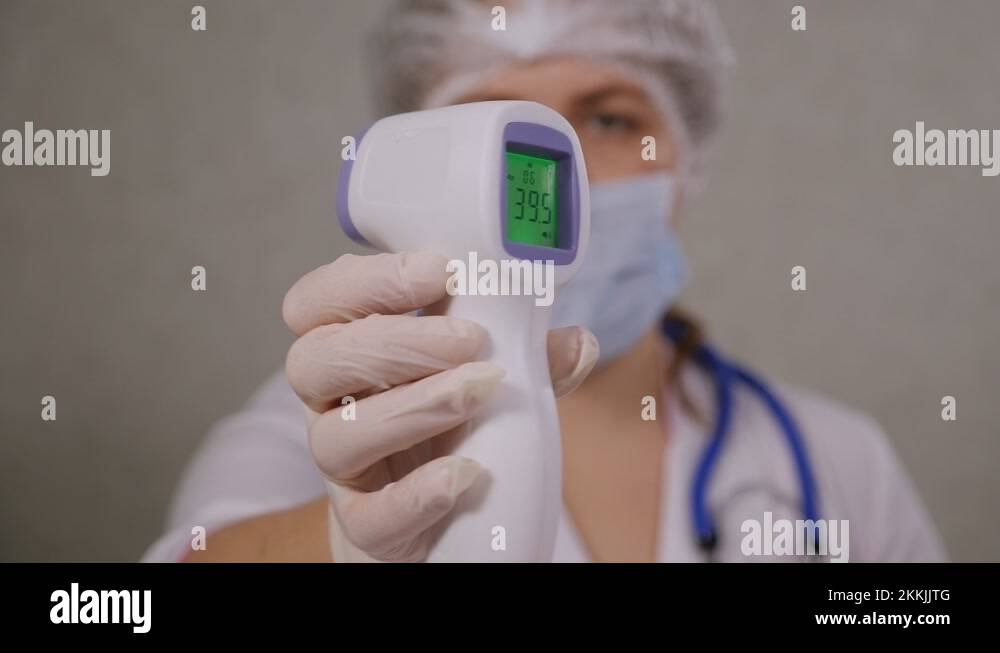 Woman in a uniform demonstrating high body temperature on infrared ...