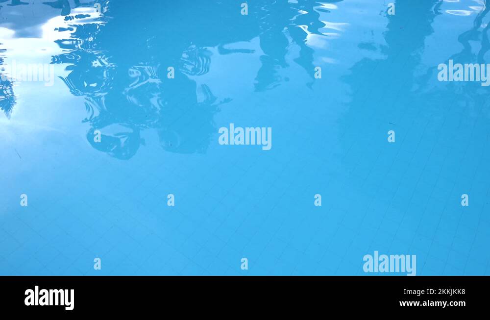 Blue clear water in swimming pool. Calm water surface motion with ...