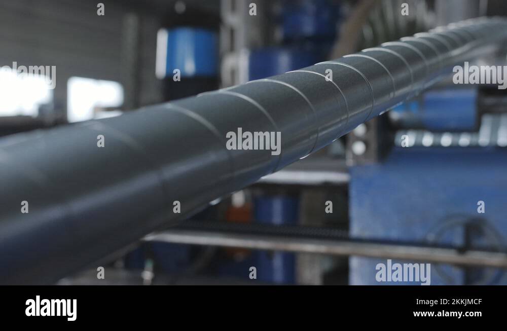 Close-up of a thick armored power cable moving along a production line ...