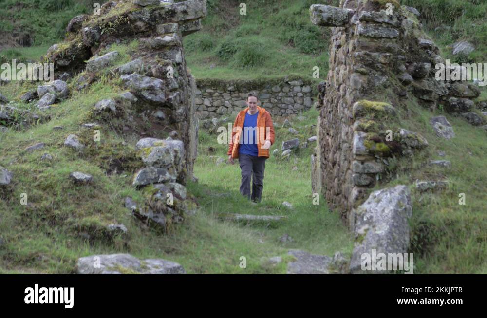 Male model walking in inca archaeological ruins, inca architecture, pre ...