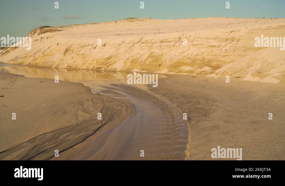 4K coastal sand erosion on beach after heavy rain as water carved her ...