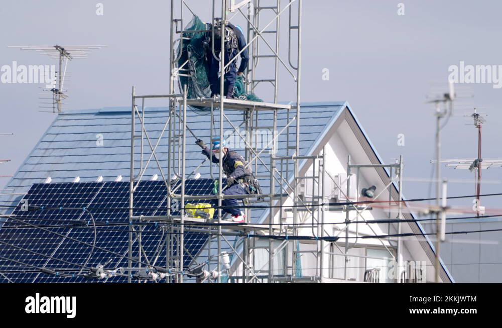 Japanese Construction Workers With Safety PPEs Working On Scaffoldings ...