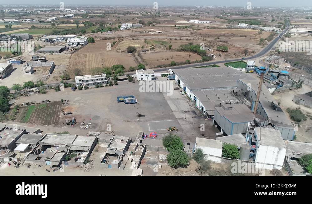 Aerial view of cement plant with high factory structure and tower crane ...