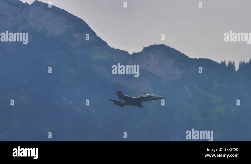 Slow motion of a moder supersonic fighter jet in flight in a narrow ...