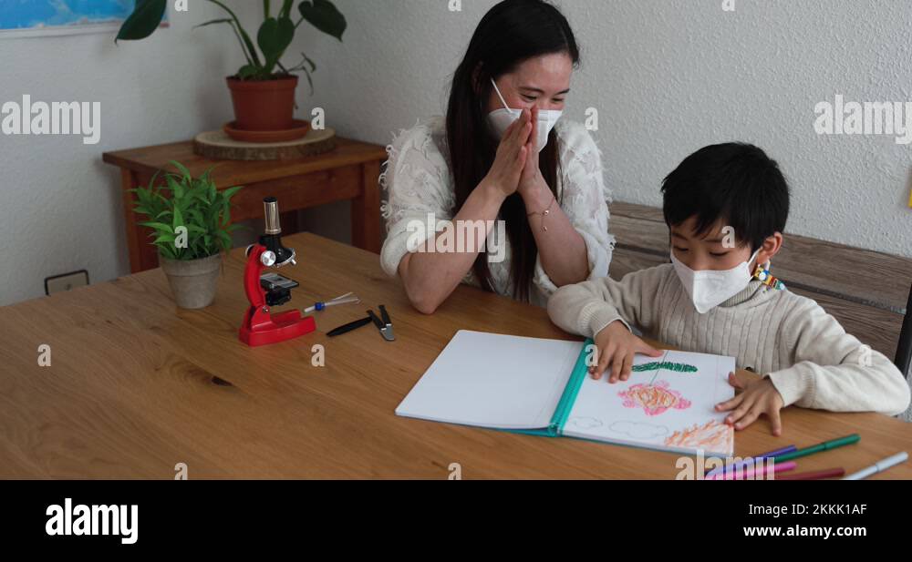 Asian female teacher clap with hands while little kid doing drawing ...
