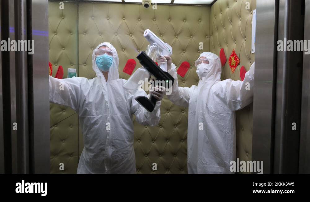 Employees wearing PPE (Personal Protective Equipment) spray ...