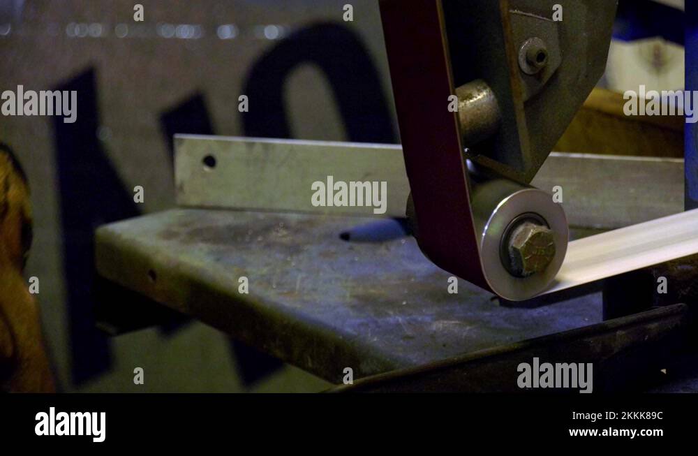 Male wearing his personal protective equipment on a grinding machine to ...