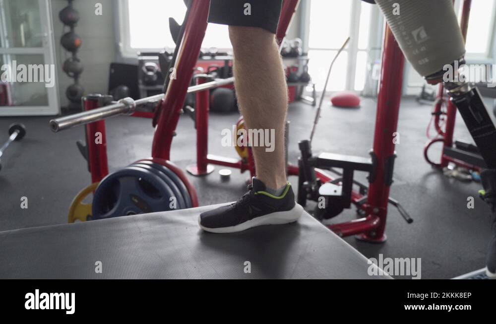 Close-up of man with prosthetic leg stepping on a jumping box in the ...