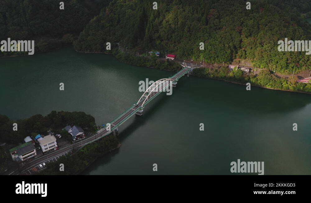 Miyama Suspension Bridge With Cars Traveling Over Pristine Lake Of ...