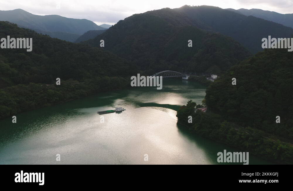 Bright Sun Reflects On Calm Water Of Lake Okutama With Mito Bridge And ...