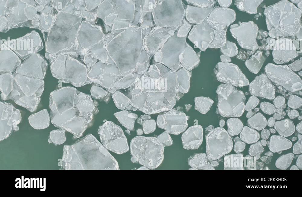 Drone Descends Toward Frozen Ice Chunks Floating in Water. Global ...