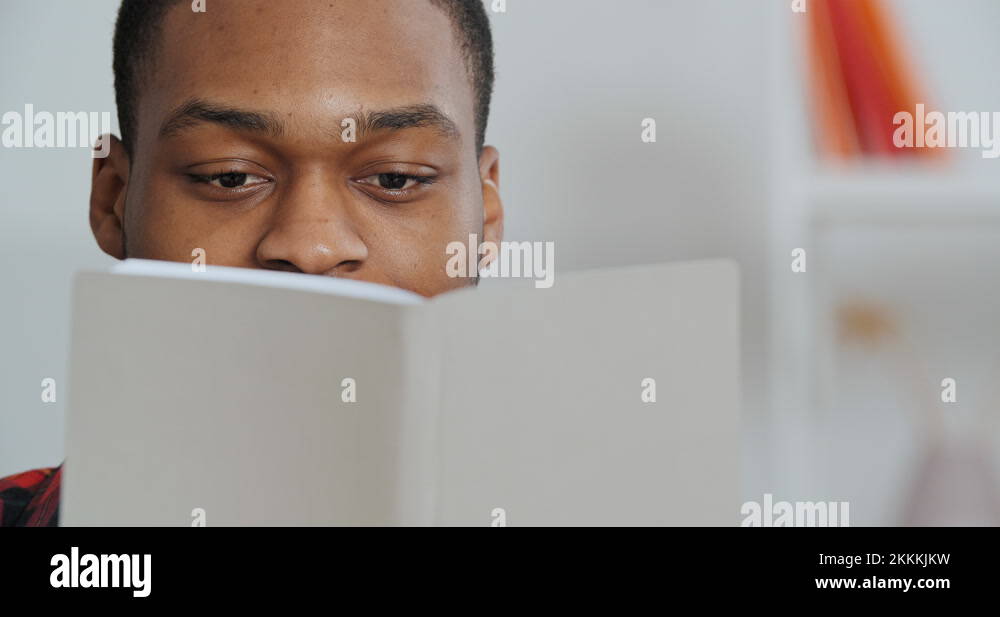 Close-up human eyes male face with dark skin and calm emotions looks ...