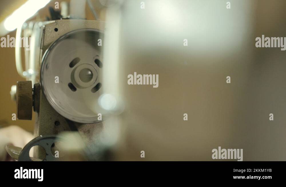 Sewing machine at work. Worker had operating a sewing machine wheel ...