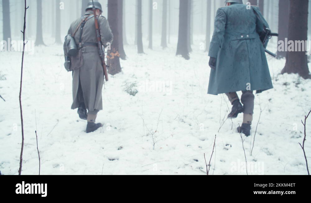 Second World War German soldiers walk side by side through winter ...