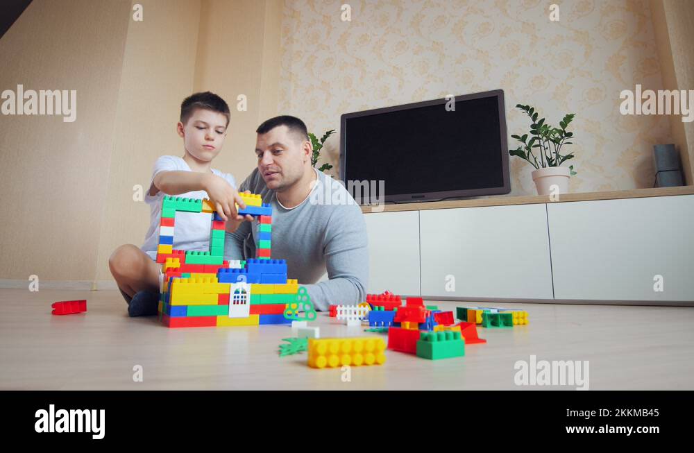 Family and childhood concept. Father and son play together and create ...