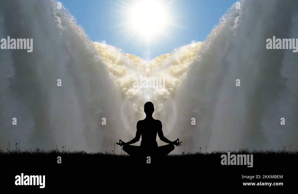 Female silhouette meditating in the lotus position in front of a giant ...