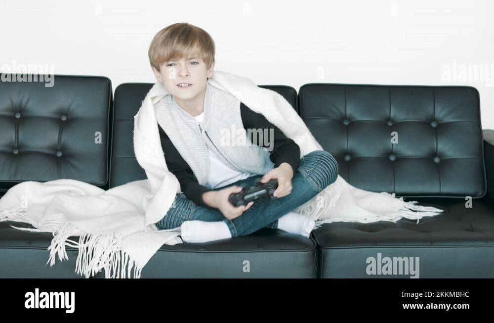 Excited emotional kid boy playing video games on modern console ...