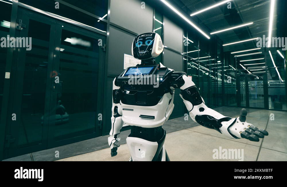 Cheerful cyborg is moving its arms while being in the business hall ...