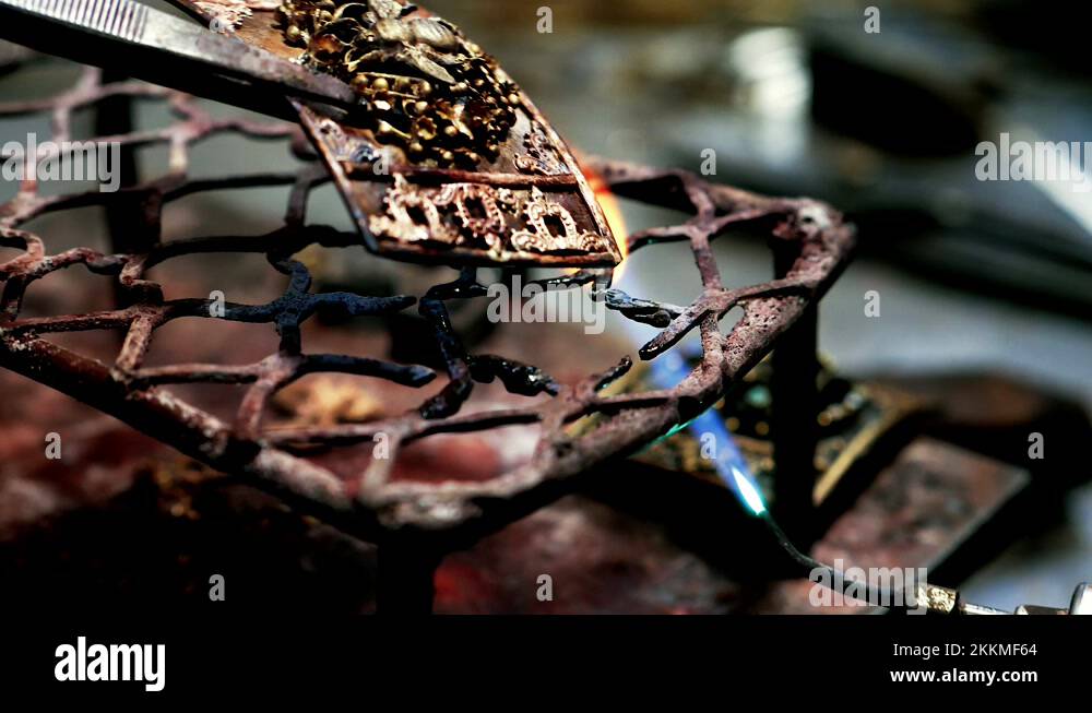 blacksmith soldering a belt buckle using a torch burner Stock Video ...