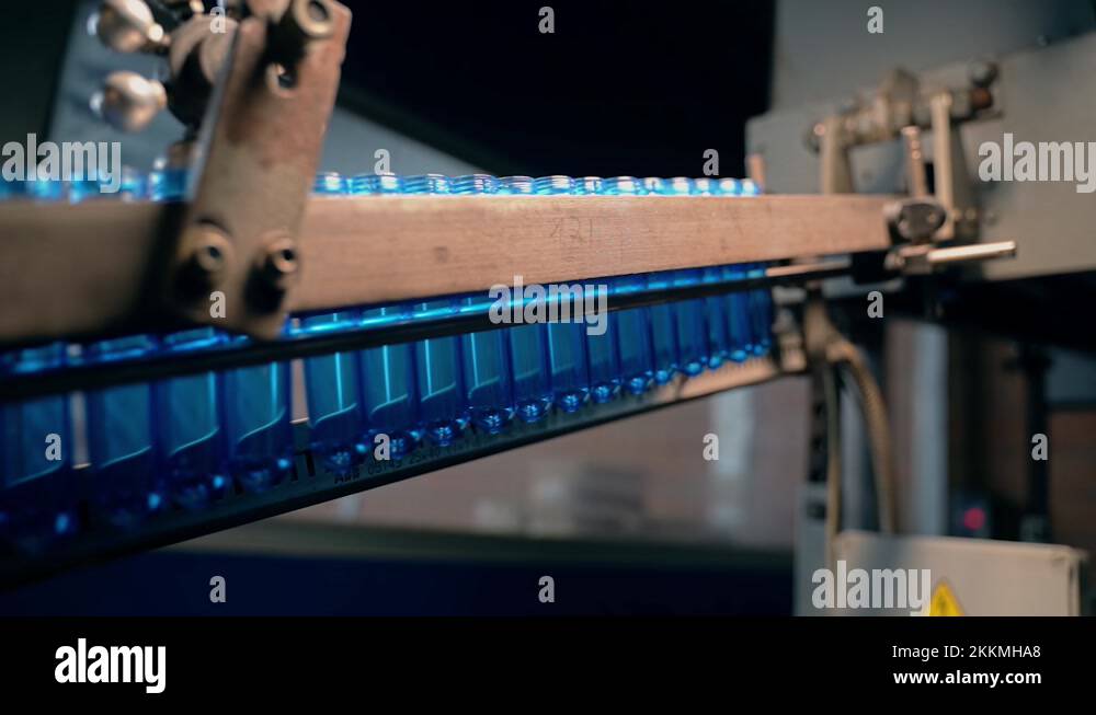 Inserting empty plastic bottle preforms into a conveyor belt Stock ... Inserting empty plastic bottle preforms into a conveyor belt Stock ...