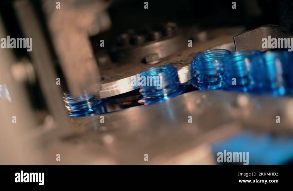 Inserting empty plastic bottle preforms into a conveyor belt Stock ... Inserting empty plastic bottle preforms into a conveyor belt Stock ...