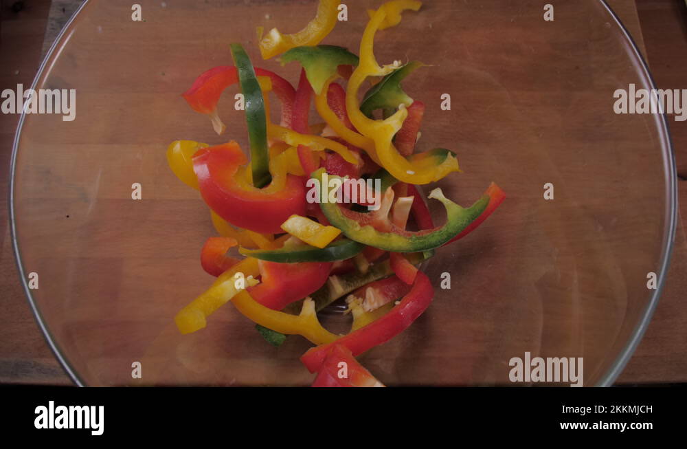 sliced red, green, yellow bell pepper falling into glass bowl slow motion 4k Stock Video Footage ...