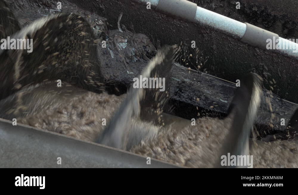 Wastewater treatment plant conveyor screw transports waste material ...
