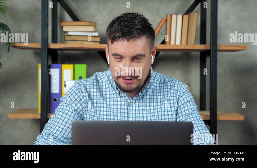 Businessman tells online video call webcam laptop company employees in ...