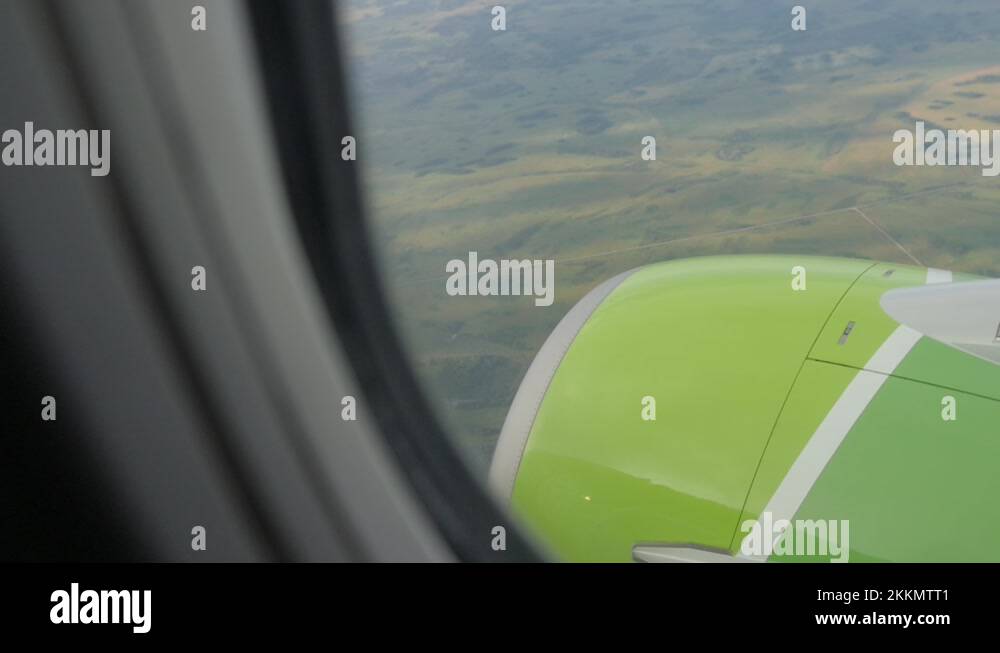 Airplane flight. Wing of an airplane flying above the clouds with ...