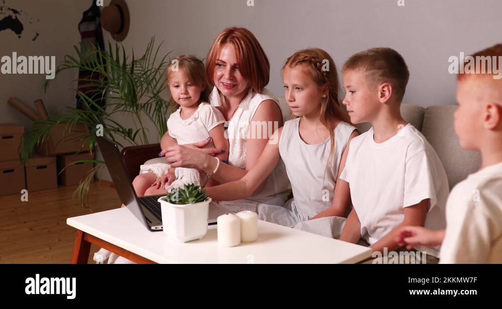 mom helps son do homework on distant learning during quarantine. Mom ...
