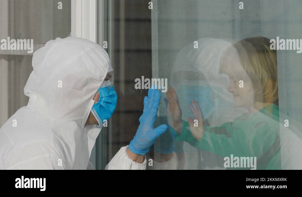 Doctor with protection uniform goodbye to child indoor, father and son ...