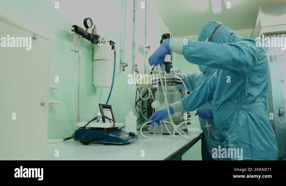 Research Lab Specialists In Full PPE Handling Rubber Tubes For ...