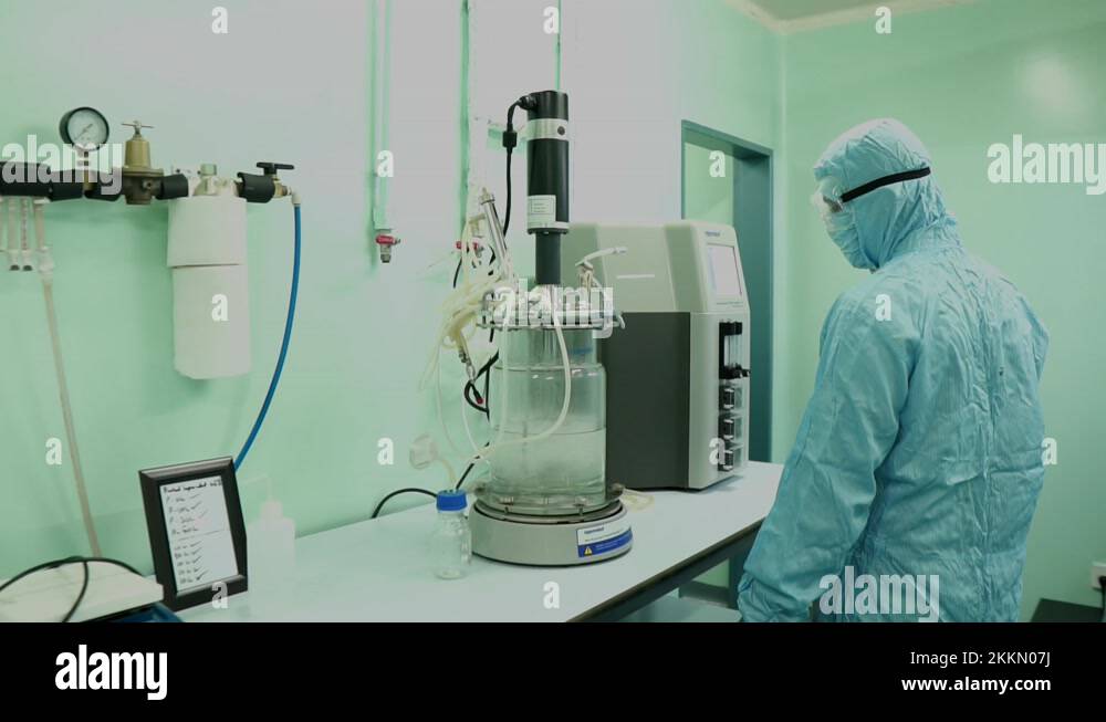 Laboratory Specialists In Full PPE Standing Next To Microbial Fermenter ...