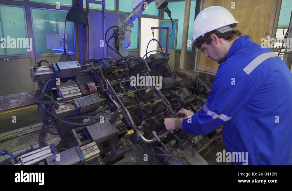 Industrial worker on quality control using steel measuring tape measure ...