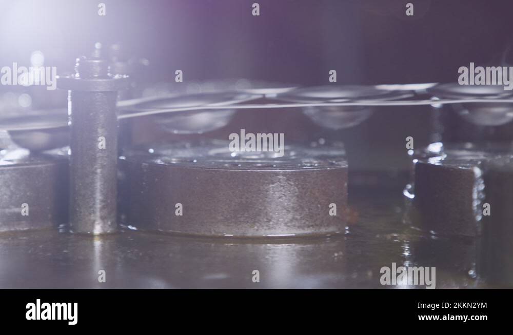 Close up of a punch press forming metal parts in a production line ...