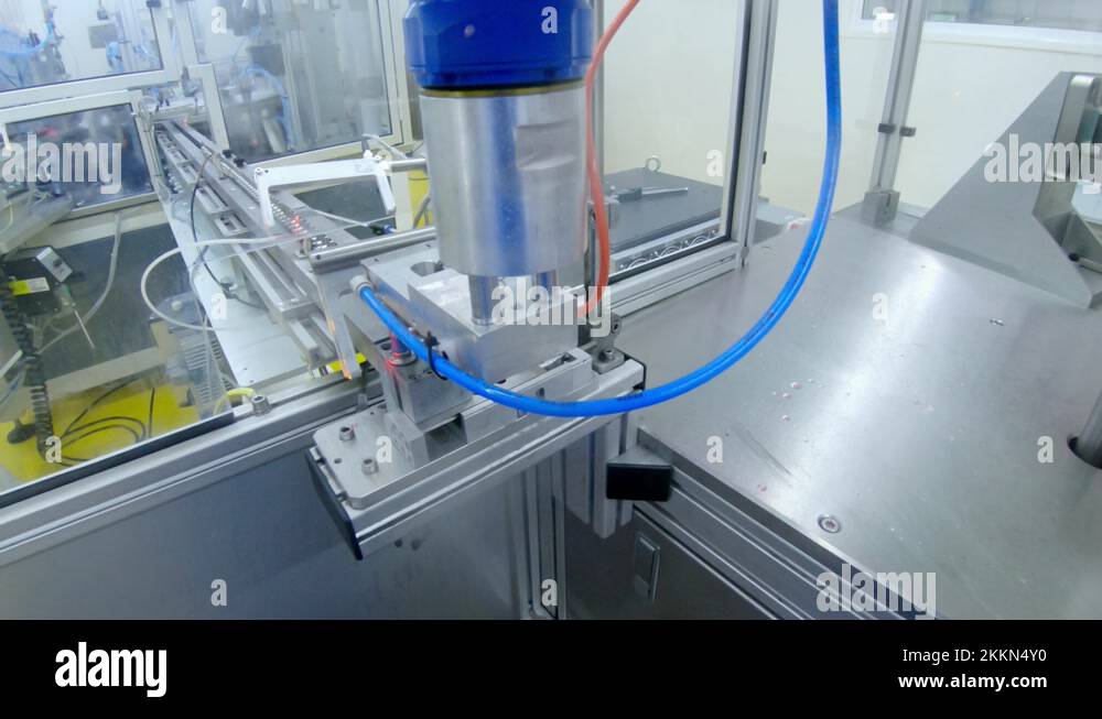 Robotic line at a manufacturing facility. Robot placing metal parts ...