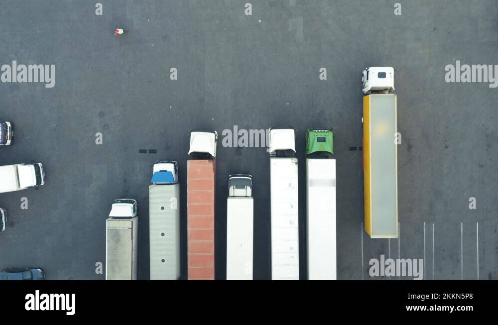 Semi-trailers trucks stand at warehouse ramps for load and unload goods ...