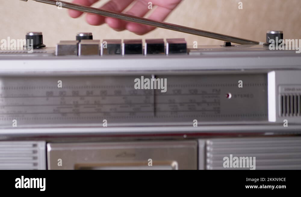 Female Hand Straightens Antenna of Gray Vintage Receiver with Cassette ...